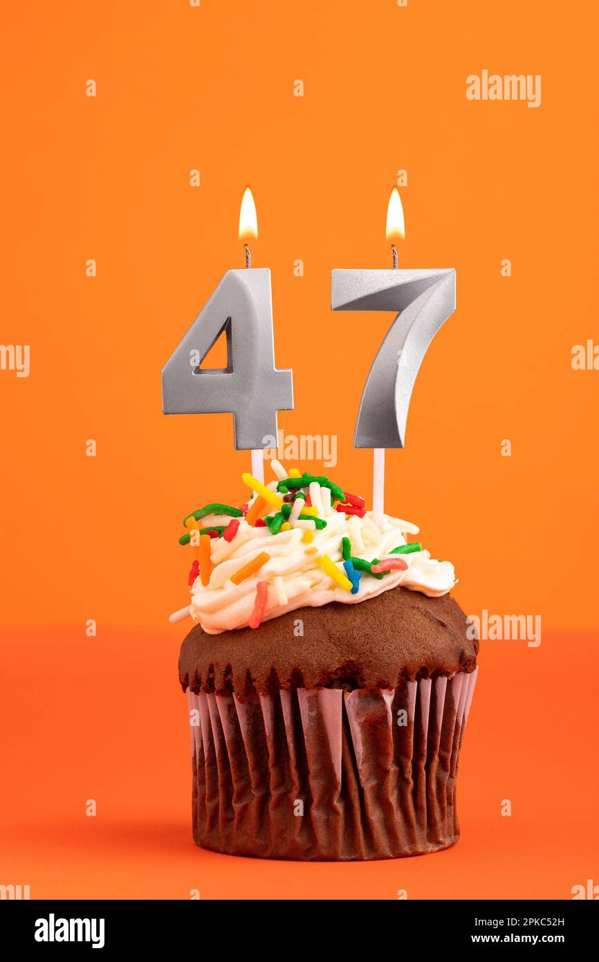 Candle number 47 - Cake birthday in orange background Stock Photo - Alamy