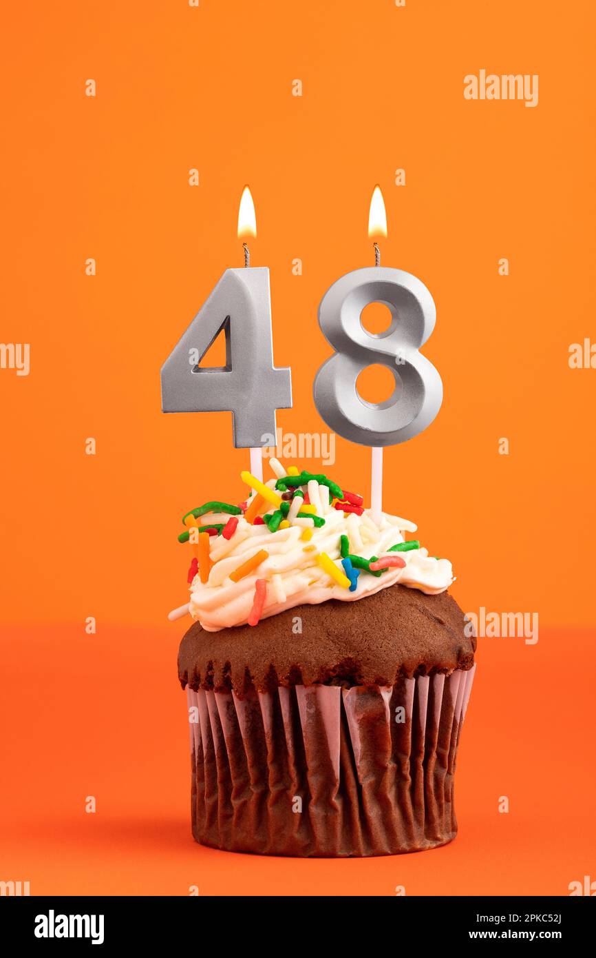 Birthday cake with candle number 48 - Orange foamy background Stock ...