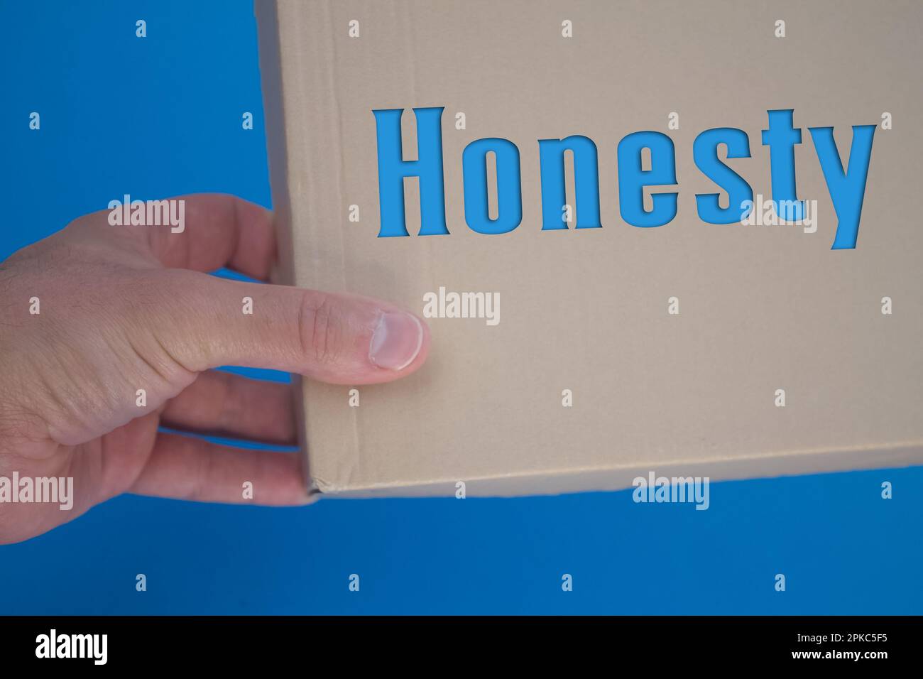 Honesty word with cardboard box. Brown folded card box Stock Photo - Alamy