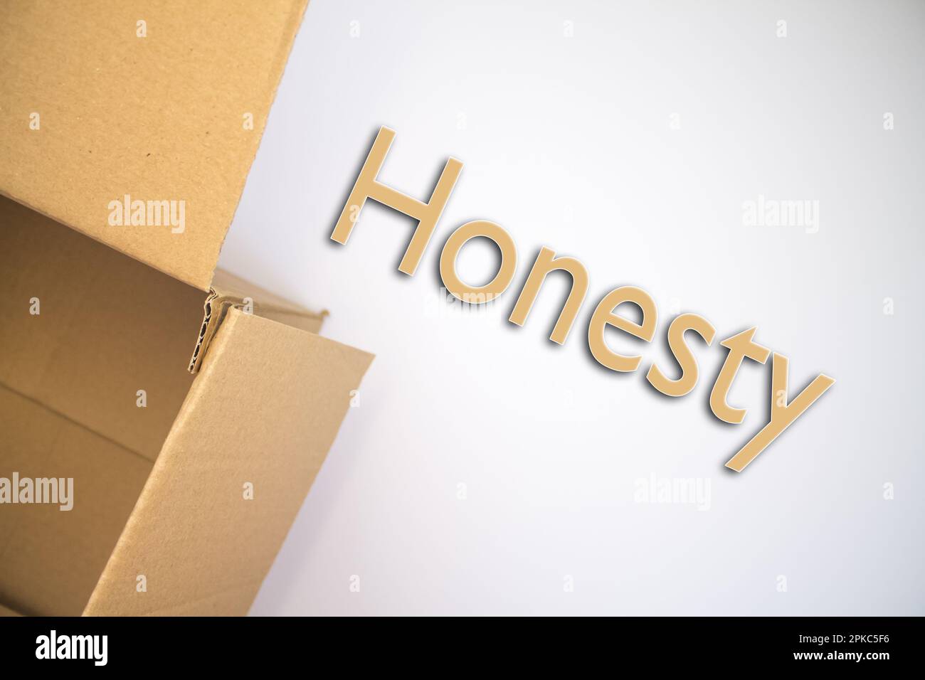 Honesty word with cardboard box. Brown folded card box Stock Photo - Alamy