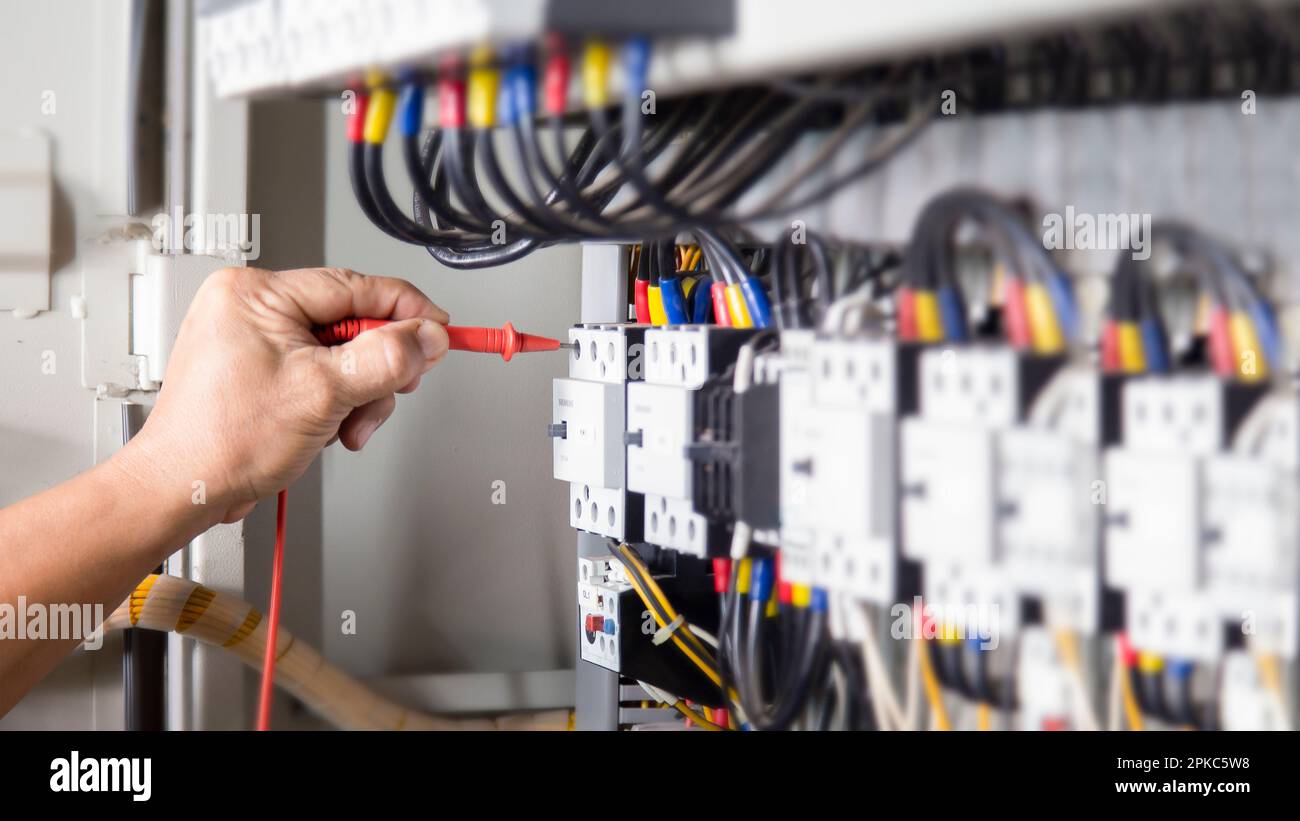 Electrical engineer checking the operation of electrical control ...