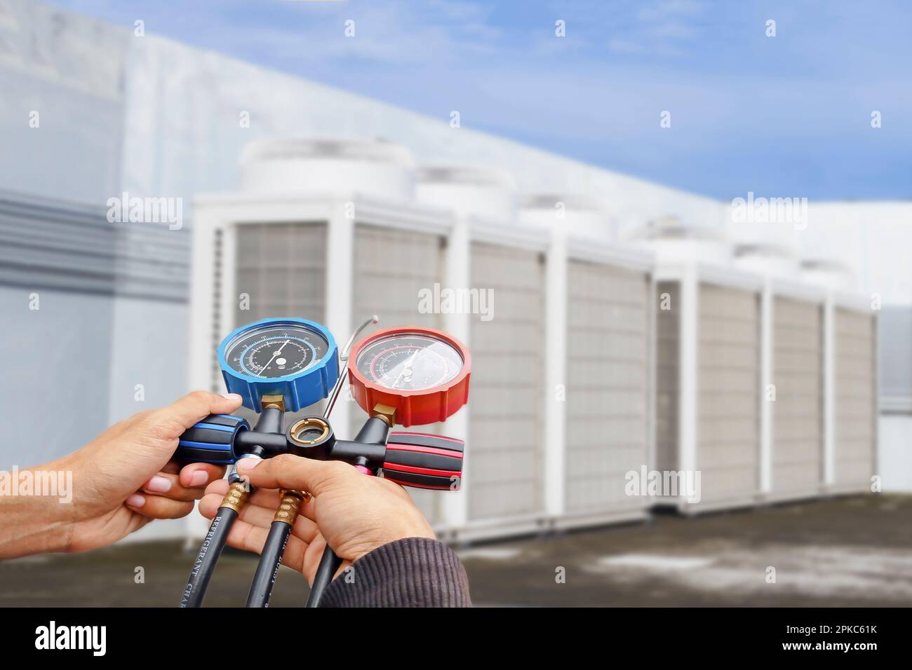 Air conditioner technician checks the operation of industrial air ...