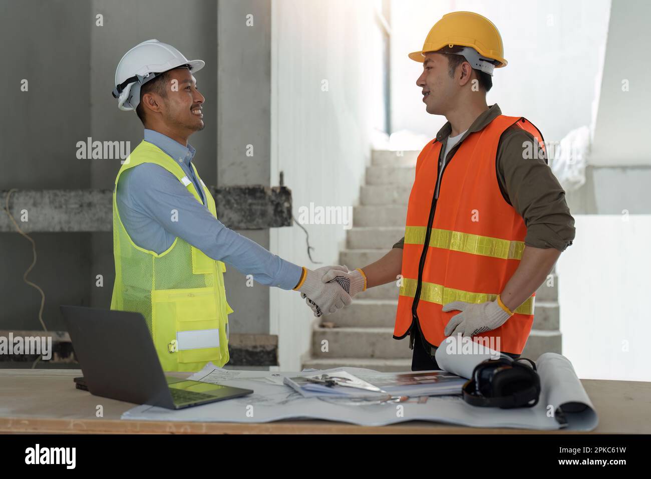 construction worker team hands shaking after consultation meeting to start up plan new project ...