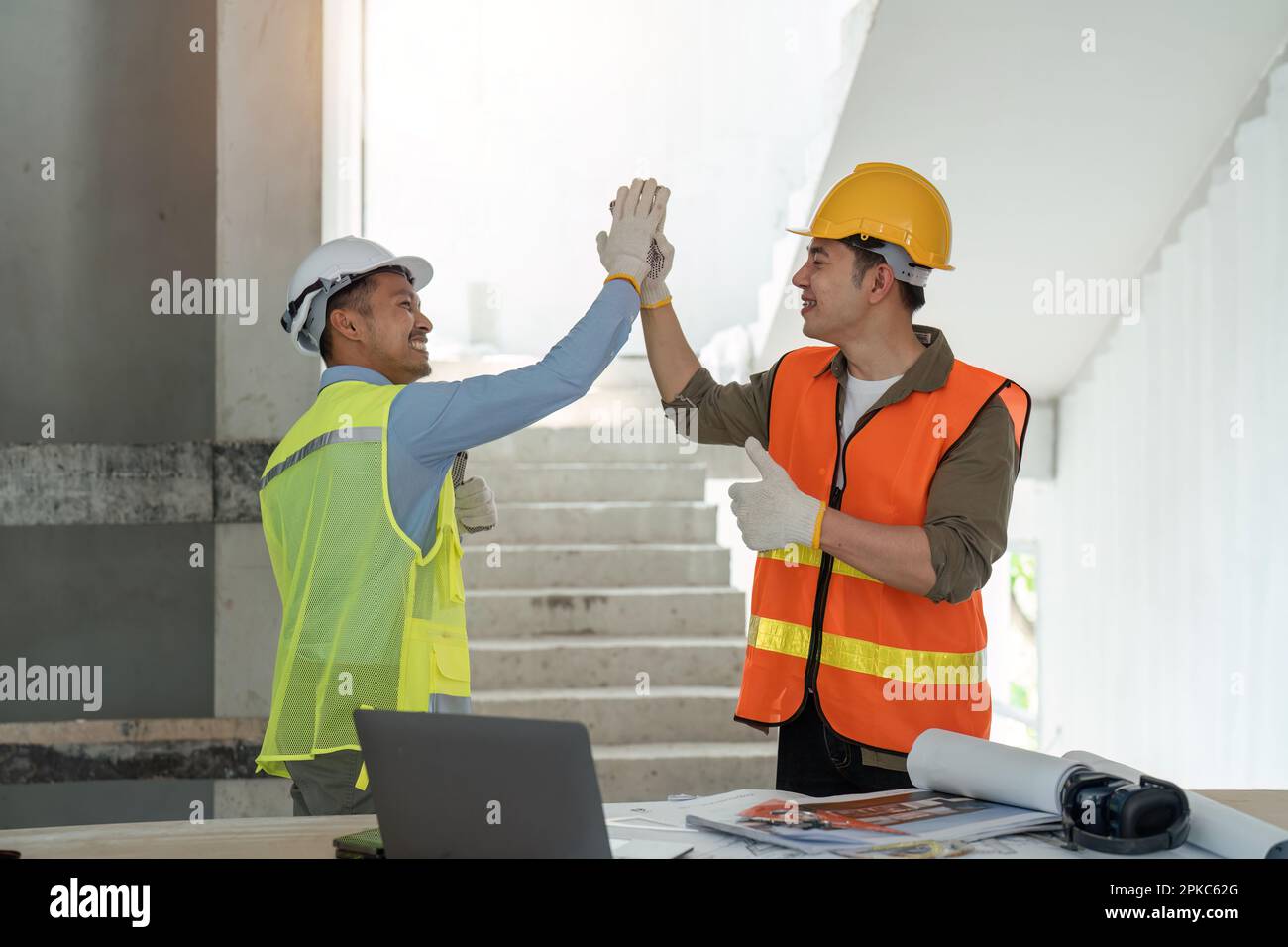 Engineer a high five to his friend colleague in the construction site ...