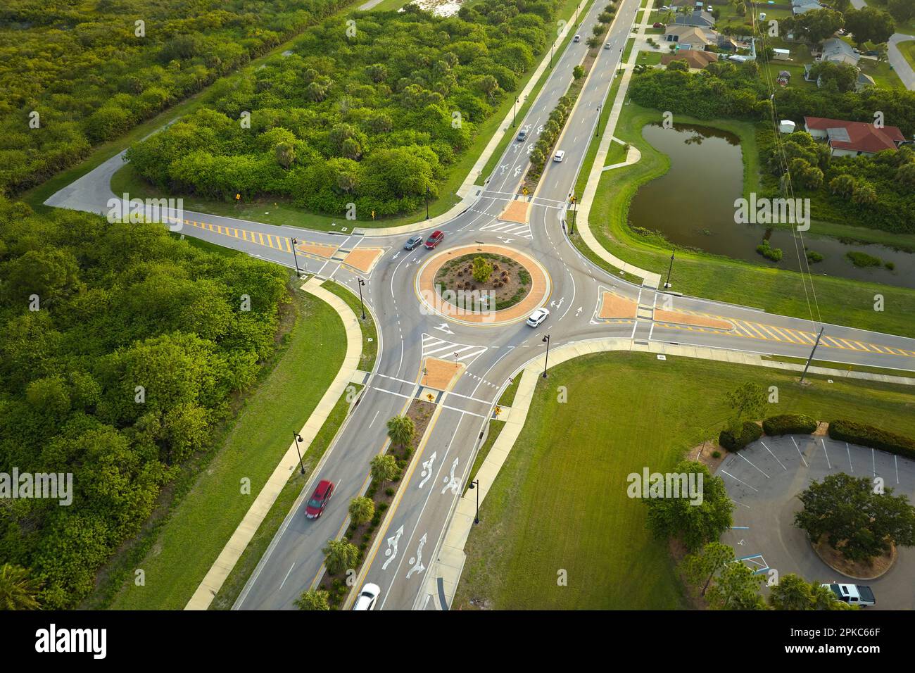 Aerial view of road roundabout intersection with moving cars traffic ...