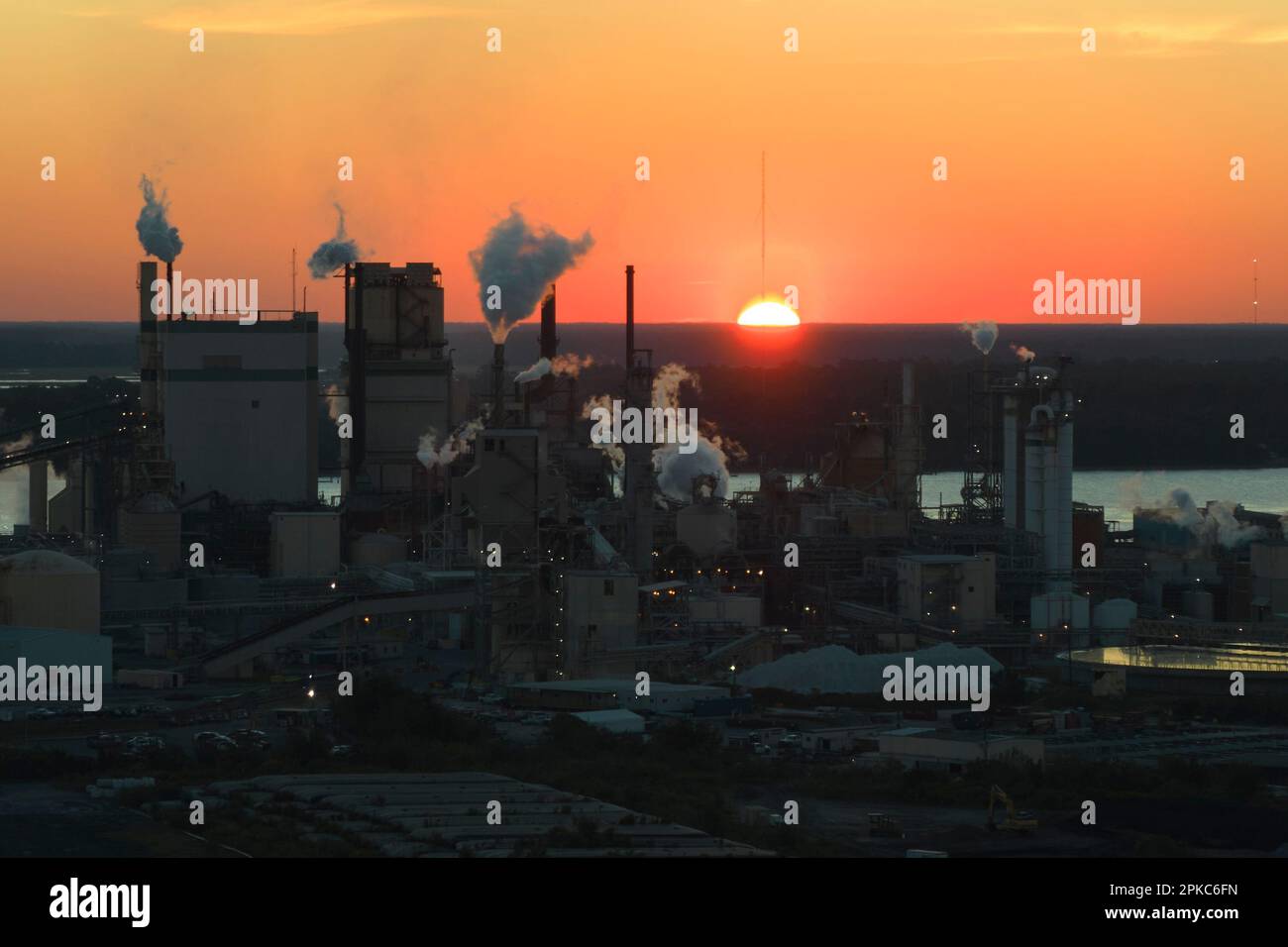 Aerial view of wood processing factory with smoke from production ...