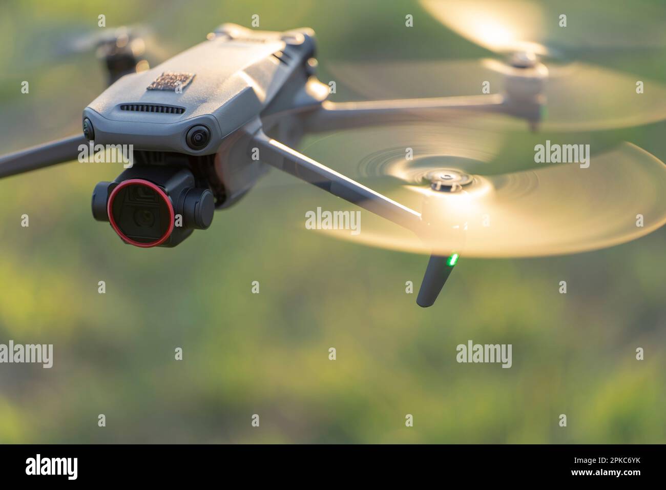 Drone aircraft with blurred fast rotating propellers and video camera ...