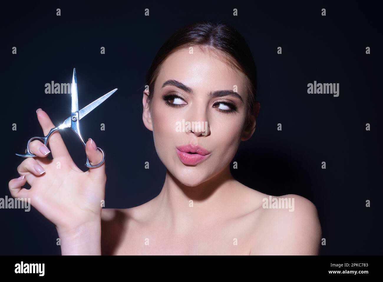 Beautiful woman with hairdresser scissors cutting hair Stock Photo - Alamy