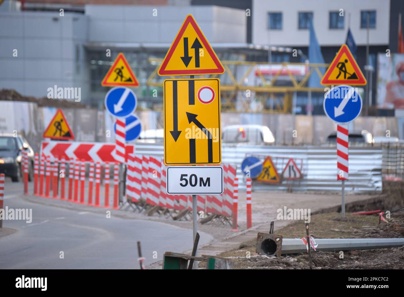 Roadworks warning traffic signs of construction work on city street and ...