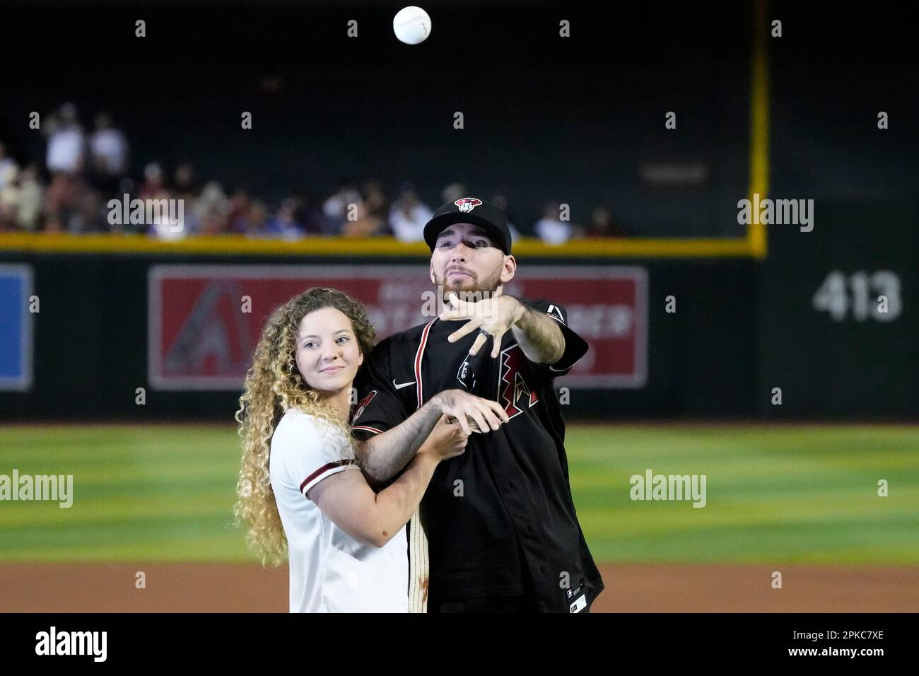 Phoenix Police Officer Tyler Moldovan, right, throws out the ceremonial ...
