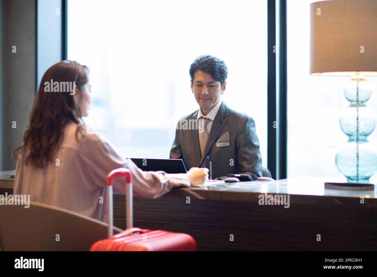 Hotel staff responding to guests Stock Photo - Alamy