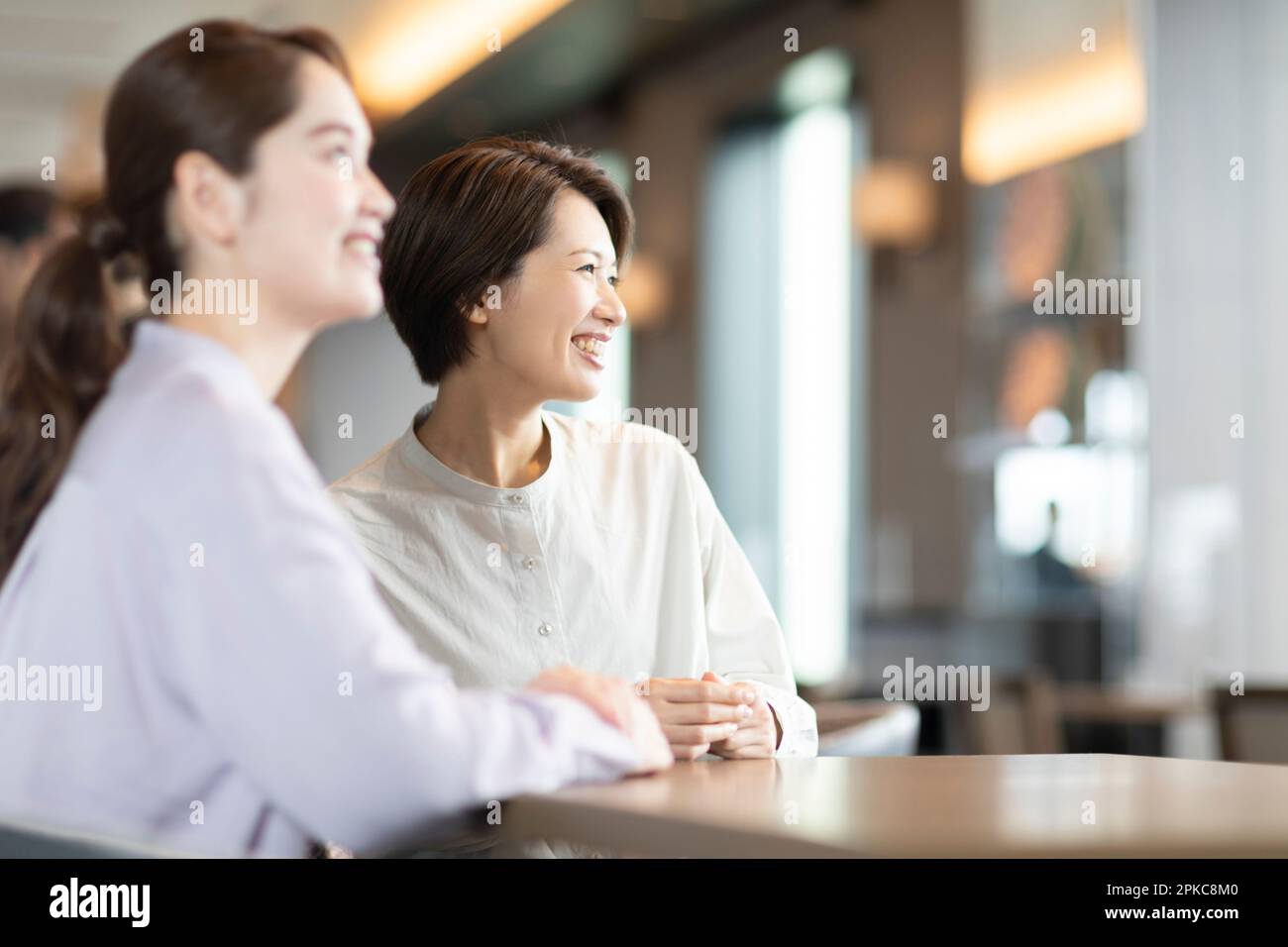Female customers being seated Stock Photo - Alamy