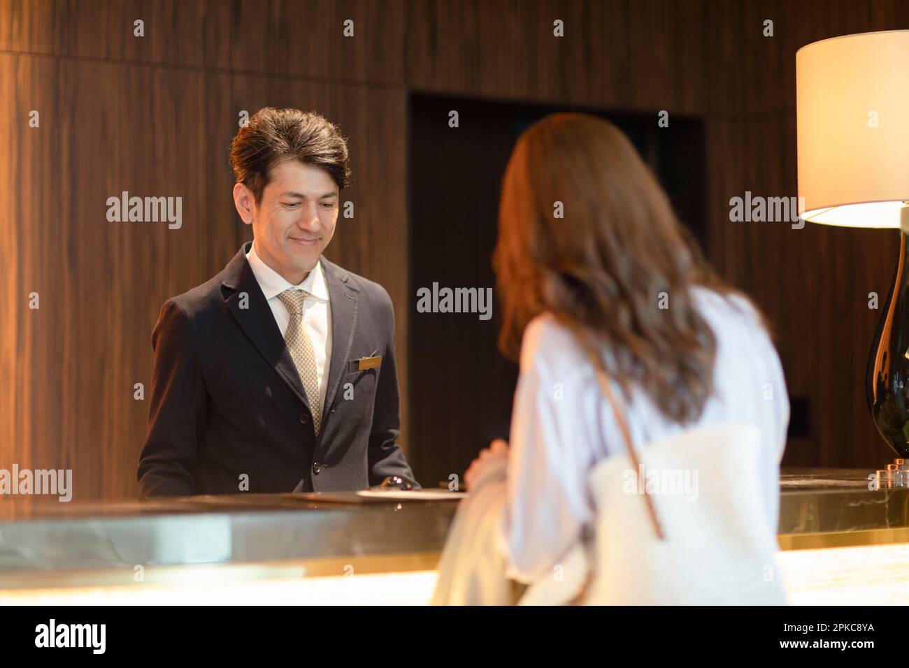 Front desk staff dealing with customers Stock Photo - Alamy