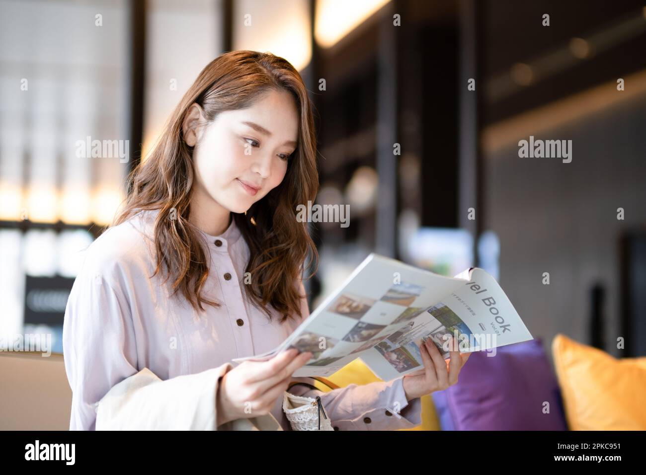 Woman reading a magazine Stock Photo - Alamy