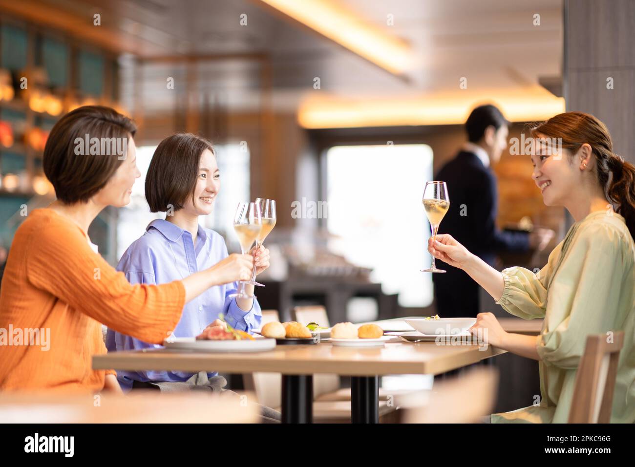 A group of women toasting Stock Photo - Alamy