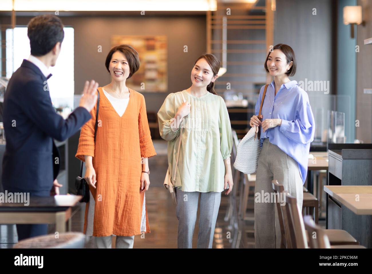Three people visiting the hotel restaurant Stock Photo - Alamy