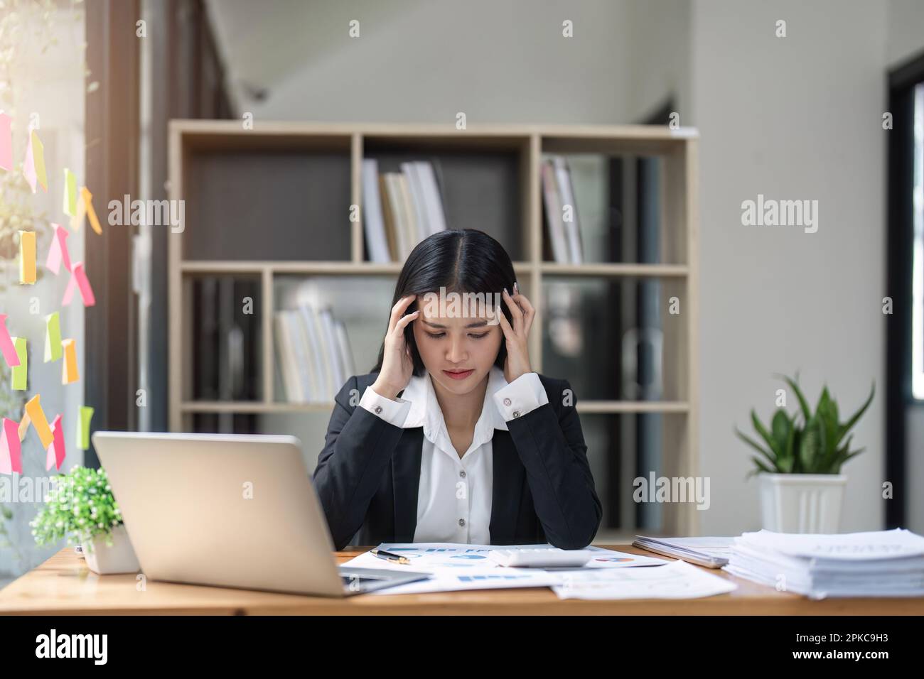 businesswoman are stressed and tired from work sitting at desk in the ...