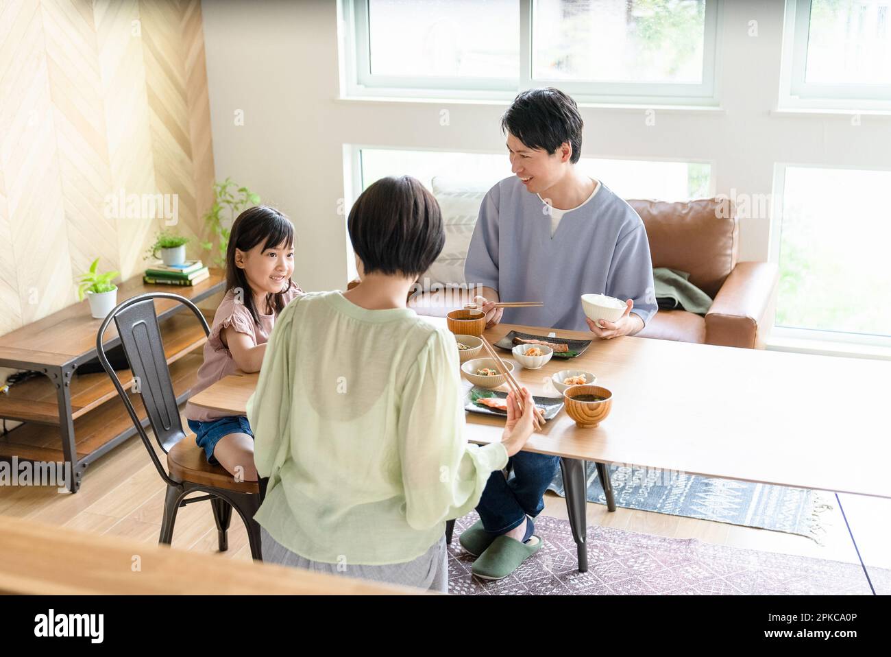 Family around the table Stock Photo - Alamy