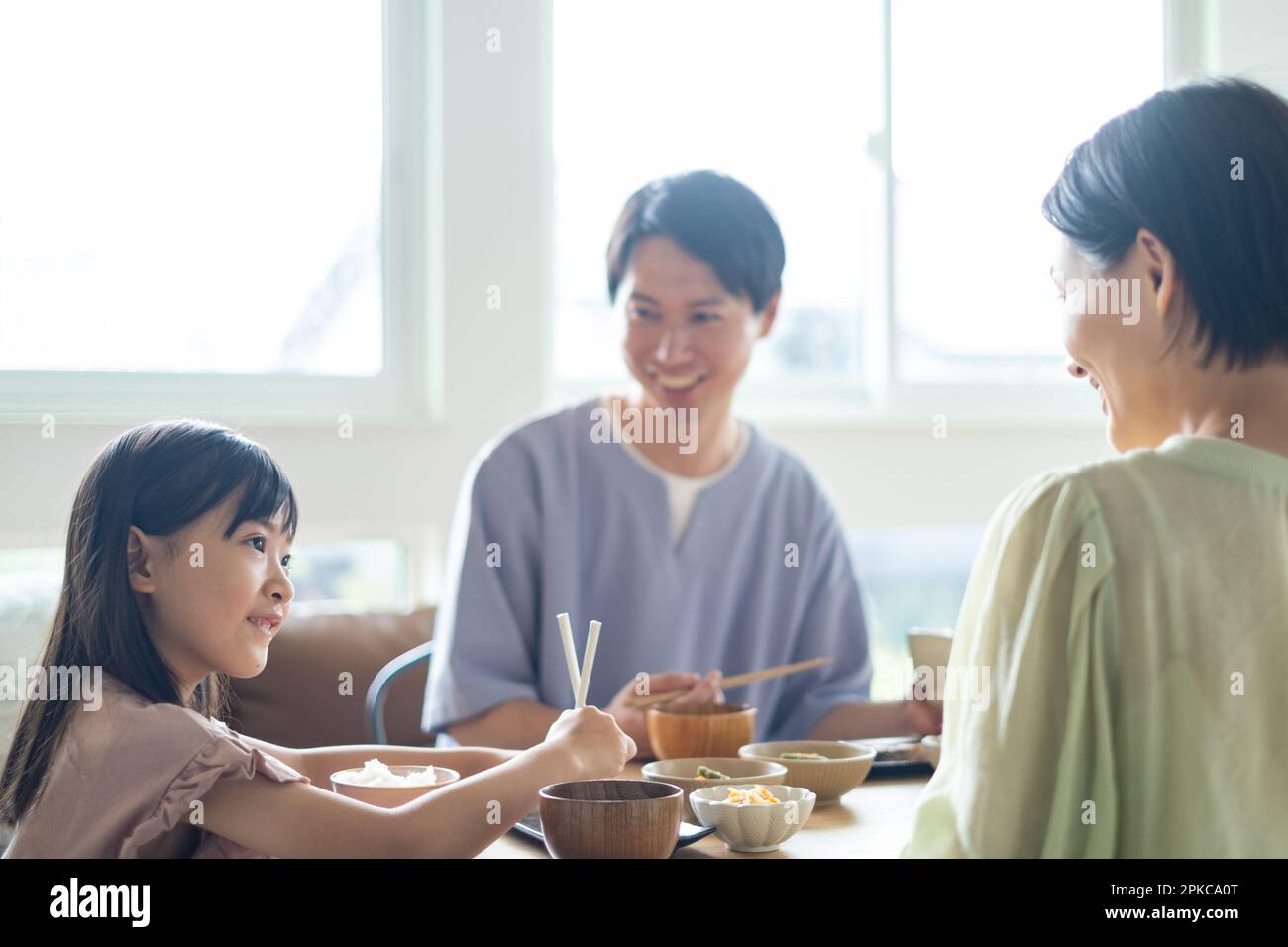 Family around the table Stock Photo - Alamy