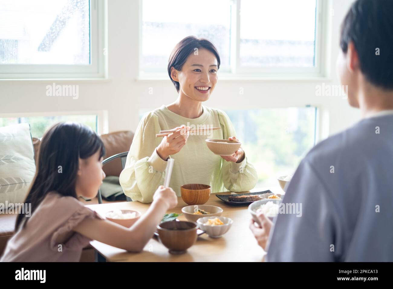 Family around the table Stock Photo - Alamy