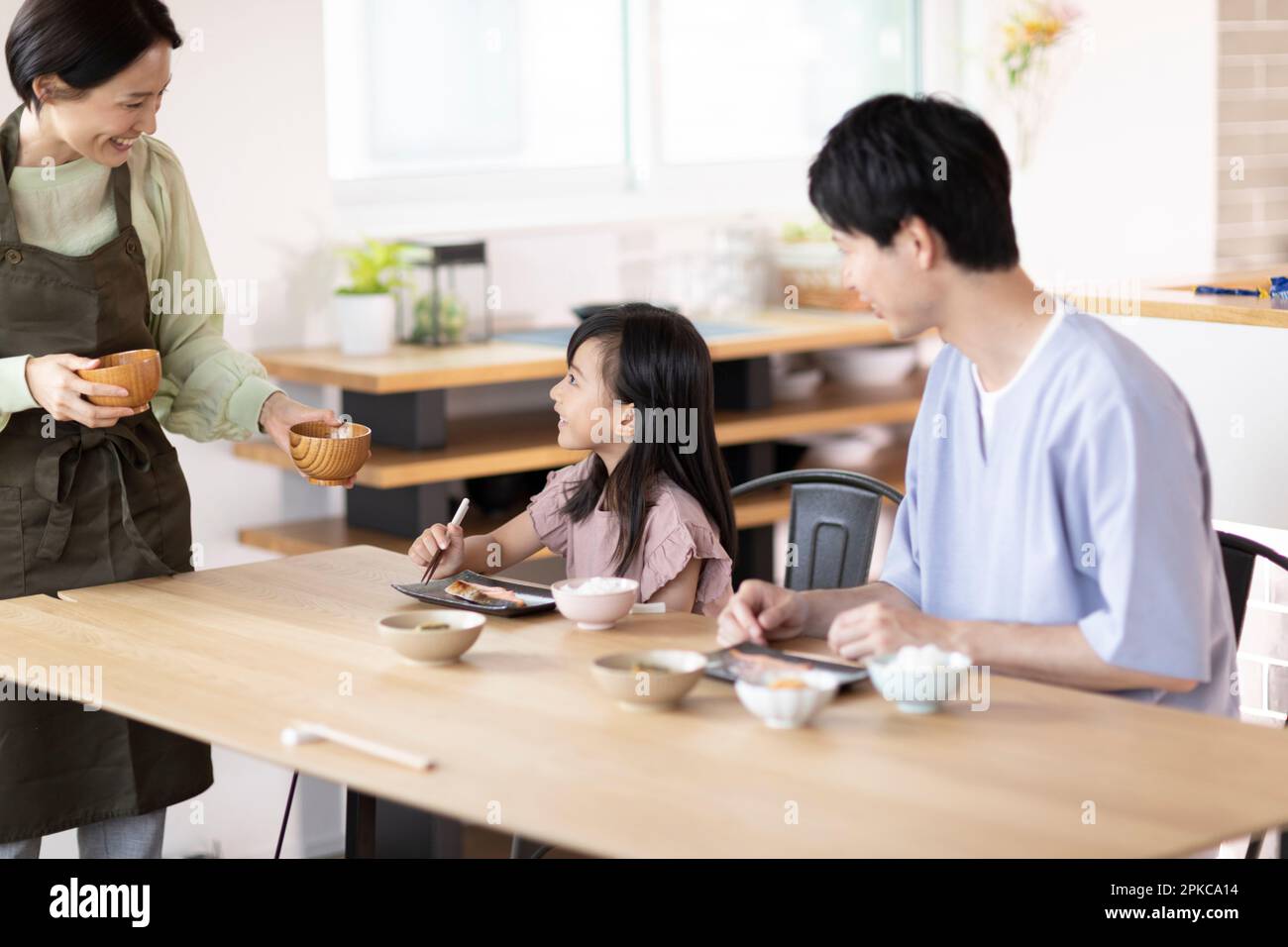 Family around the table Stock Photo - Alamy