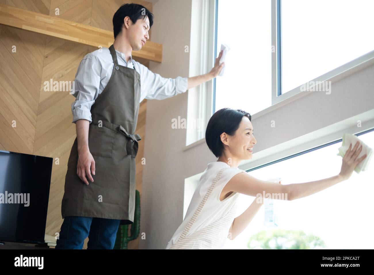 Couple wiping window Stock Photo - Alamy