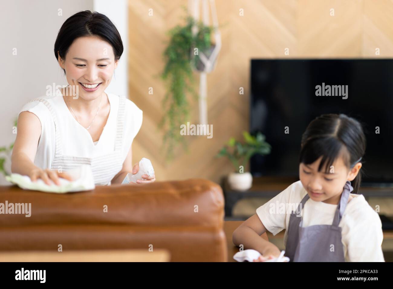 Parent and child cleaning Stock Photo - Alamy