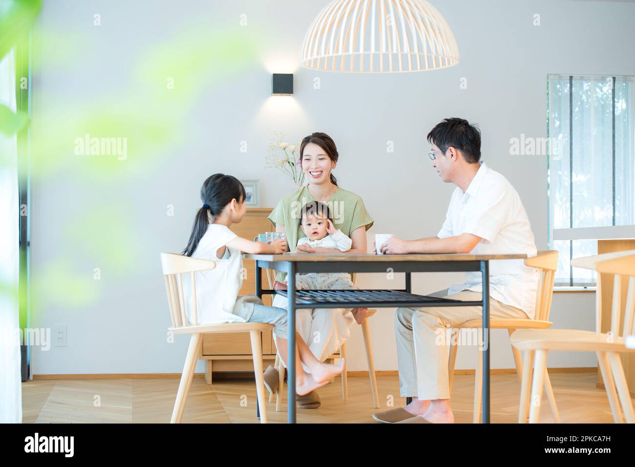 Family having a conversation in the dining room Stock Photo - Alamy