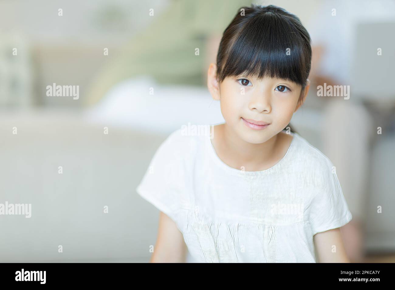 A girl looking at me and smiling Stock Photo - Alamy