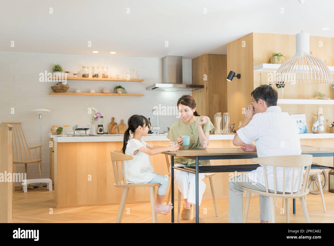 Parent and child talking in the dining room Stock Photo - Alamy