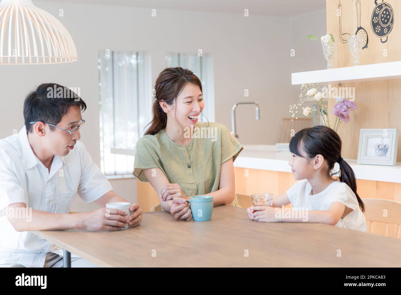 Parent and child talking in the dining room Stock Photo - Alamy