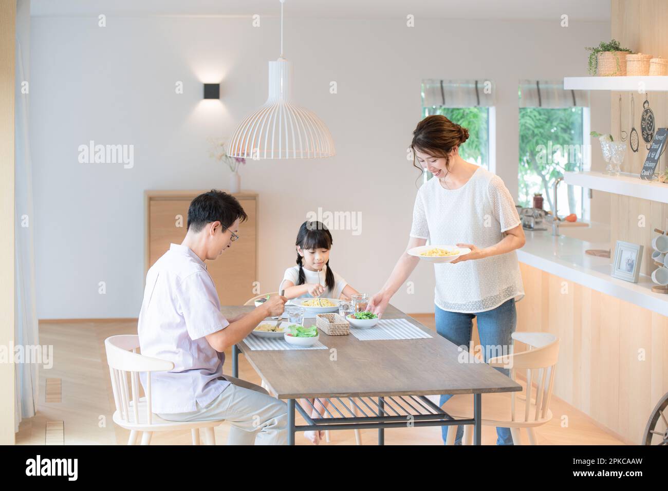 Parents and children dining in the dining room Stock Photo - Alamy