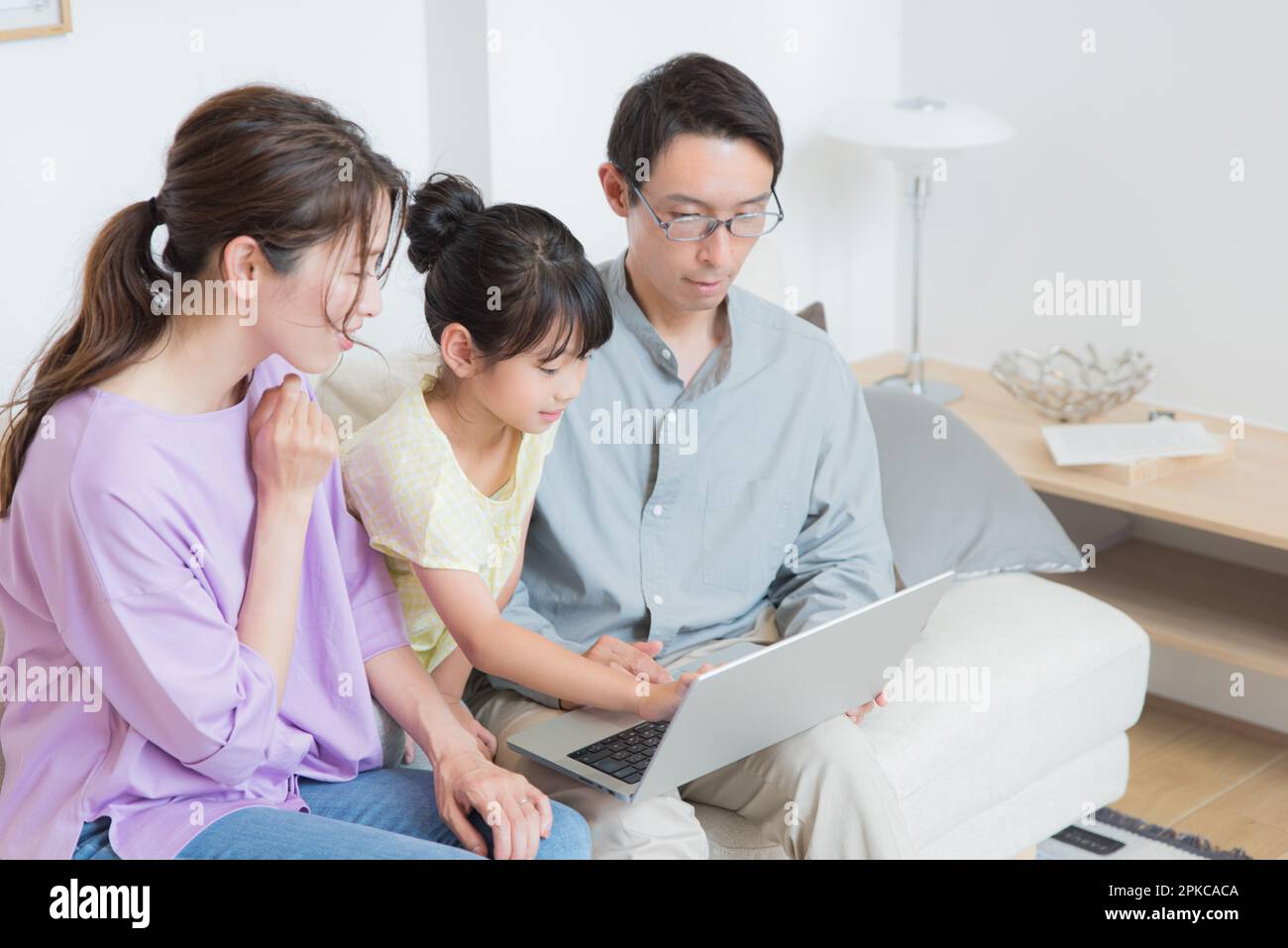 Parent and child relaxing in the living room while watching the ...
