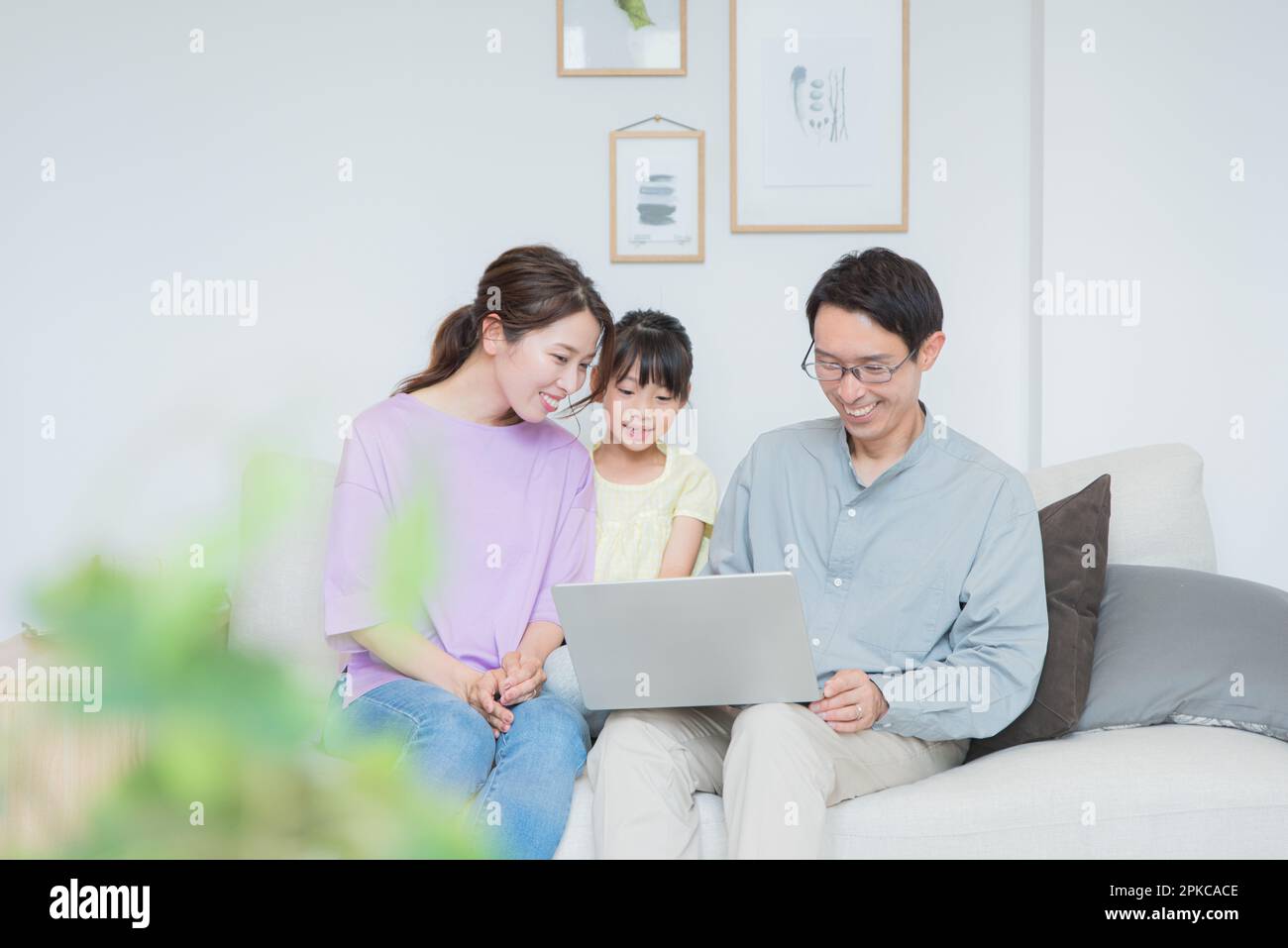Parent and child relaxing in the living room while watching the ...