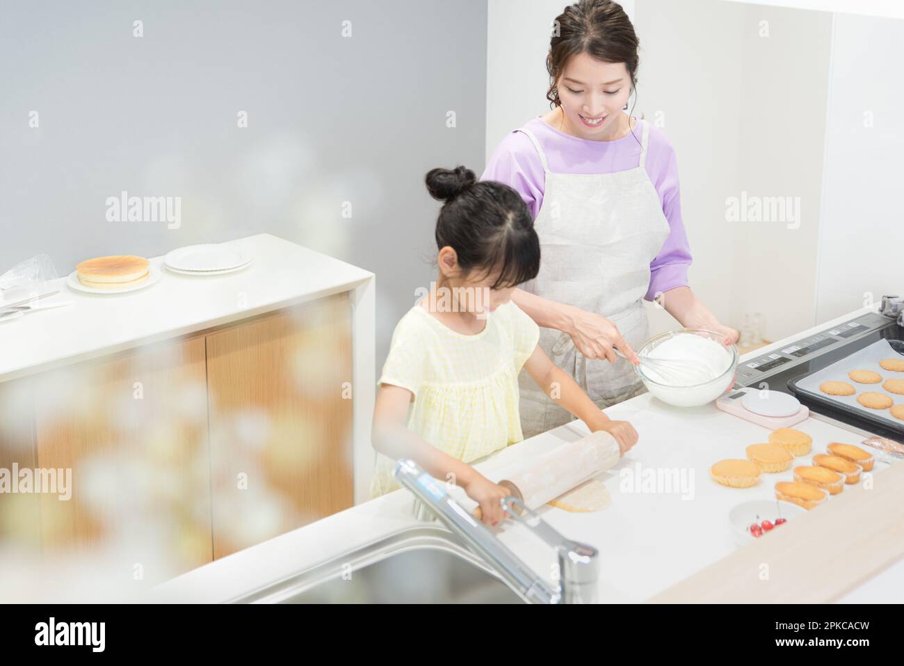 Parent and child making sweets Stock Photo - Alamy