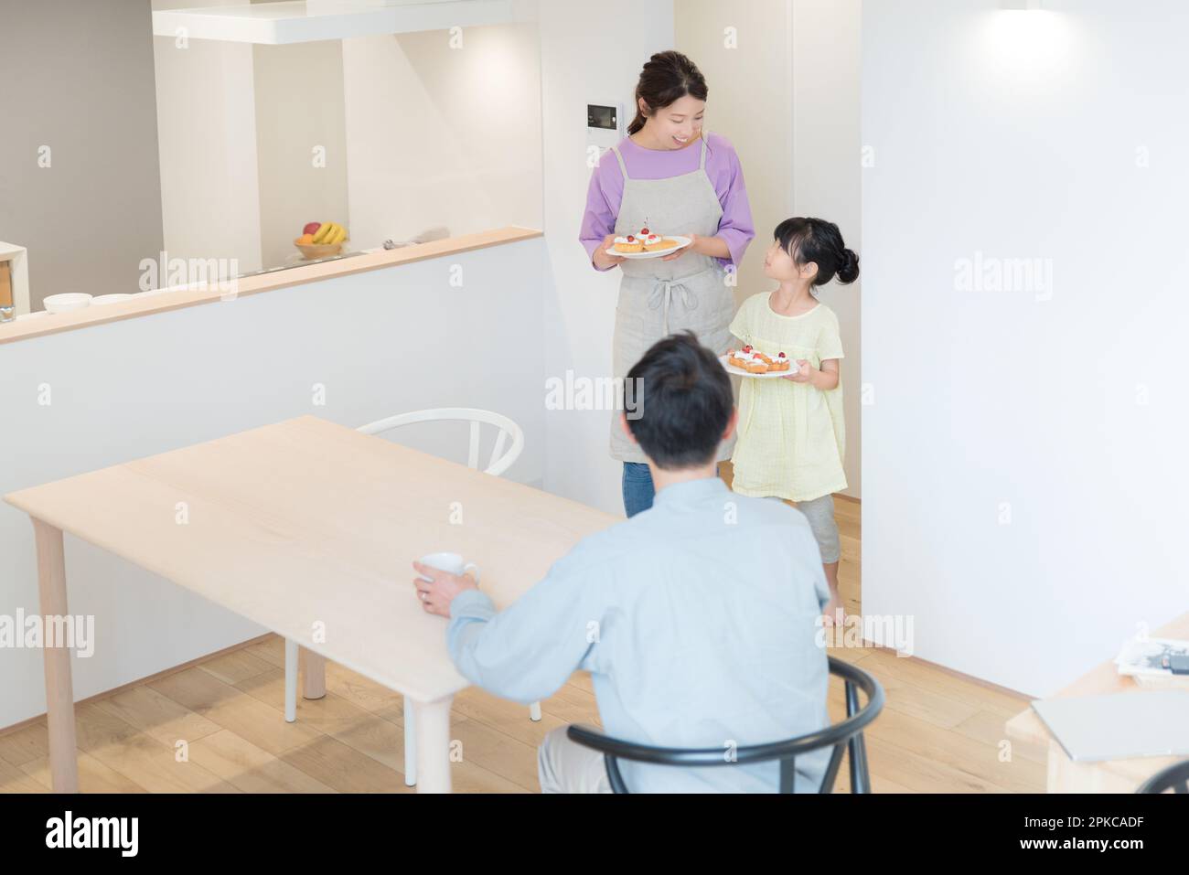 Parents and children carrying sweets to the table Stock Photo - Alamy