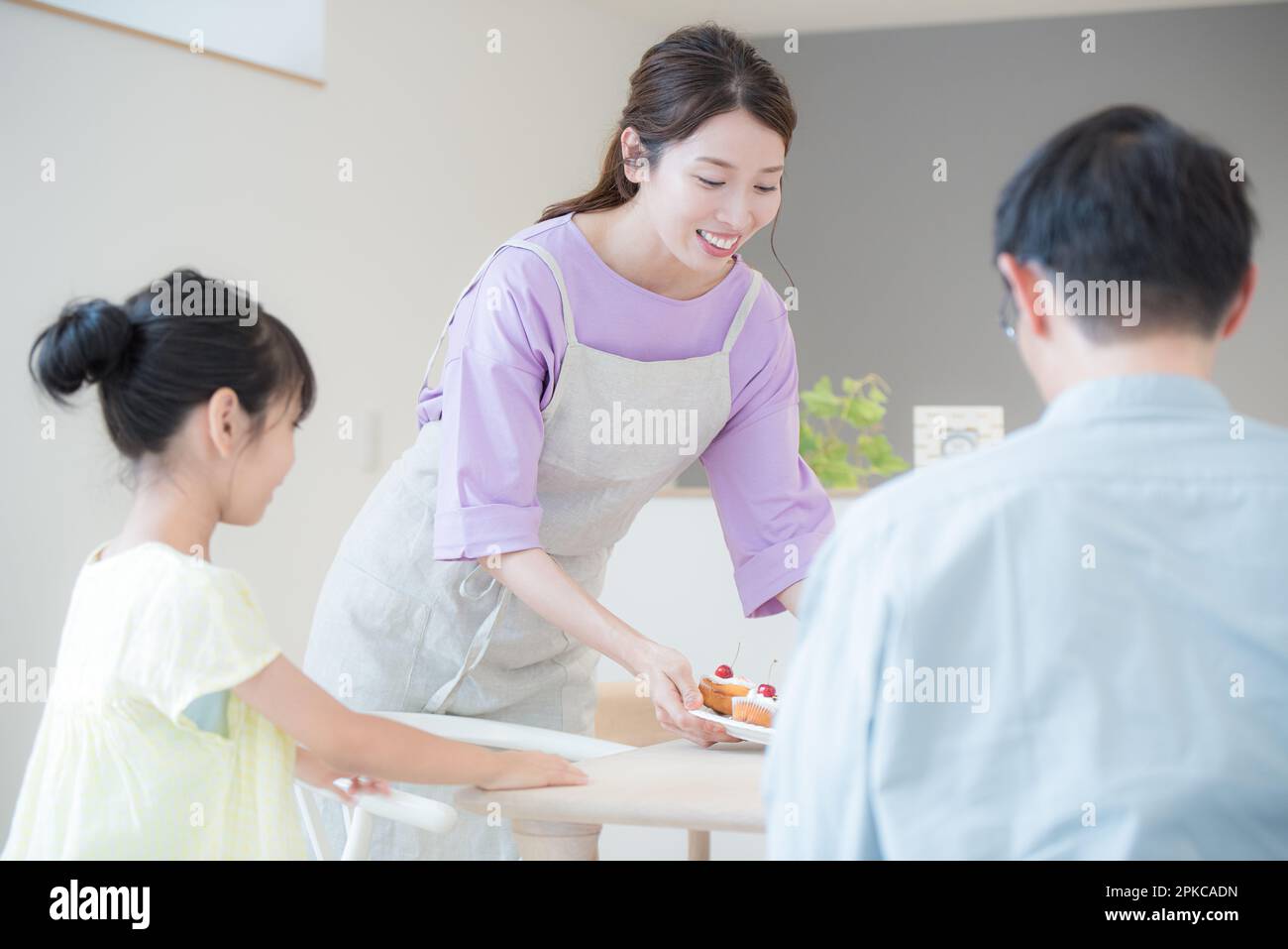 Parents and children carrying sweets to the table Stock Photo - Alamy