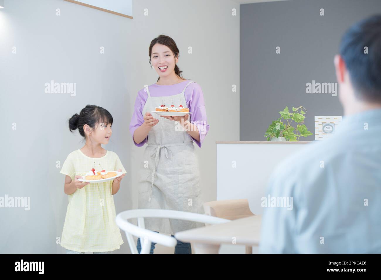 Parents and children carrying sweets to the table Stock Photo - Alamy