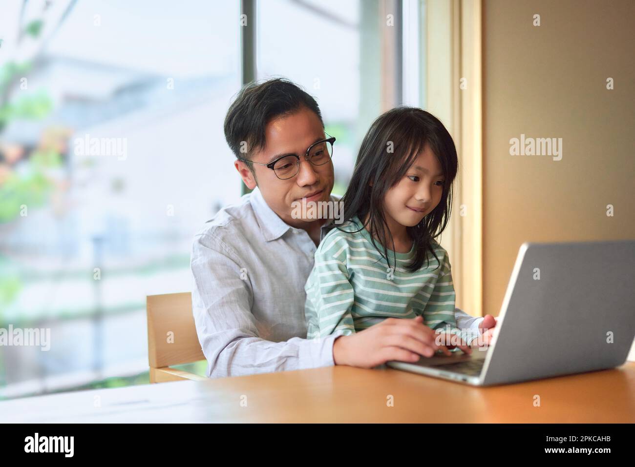 Parent and child operating a computer Stock Photo - Alamy