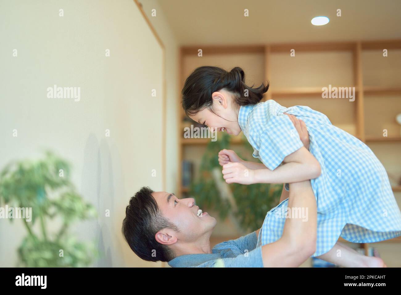 Parent and child frolicking in the living room Stock Photo - Alamy