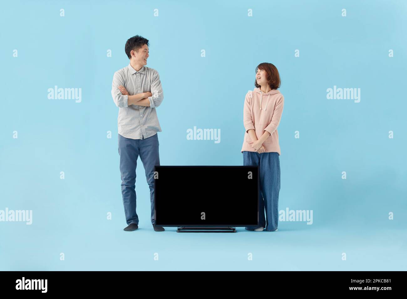 Couple staring at TV Stock Photo - Alamy