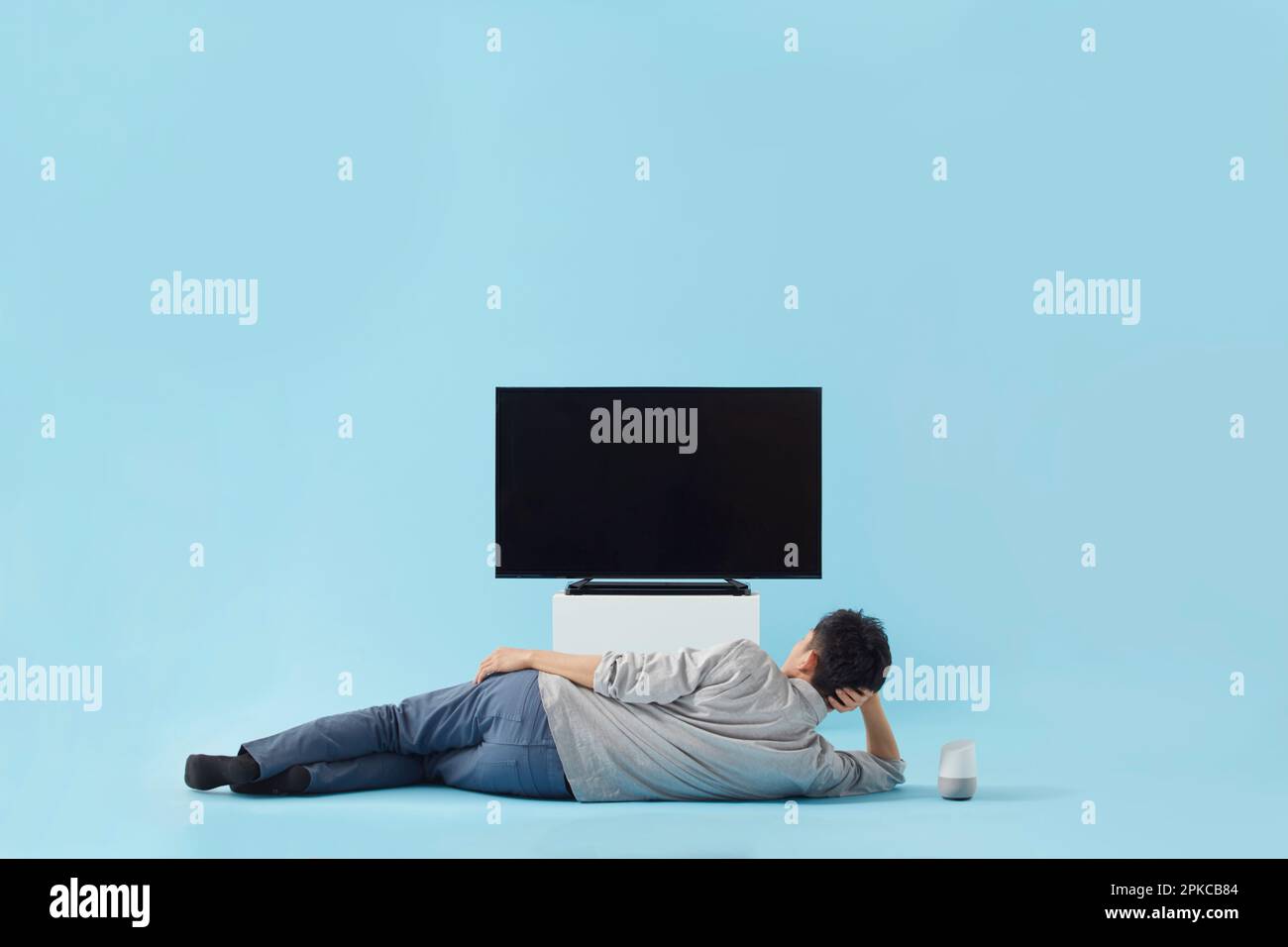Man lying down in front of TV Stock Photo - Alamy