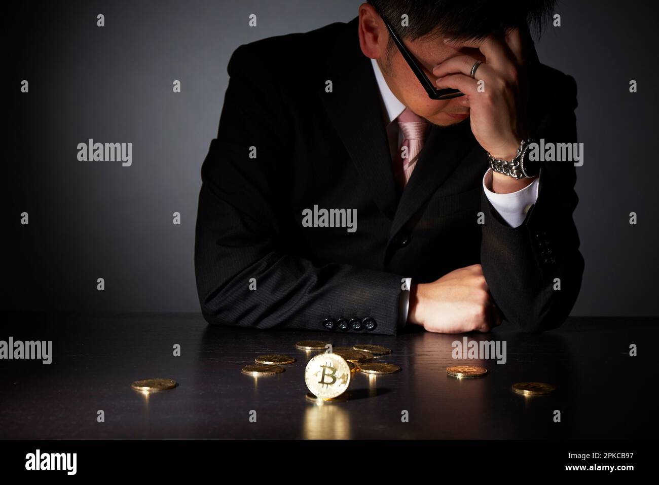 Man in suit with head held up after business failure with bitcoin Stock ...