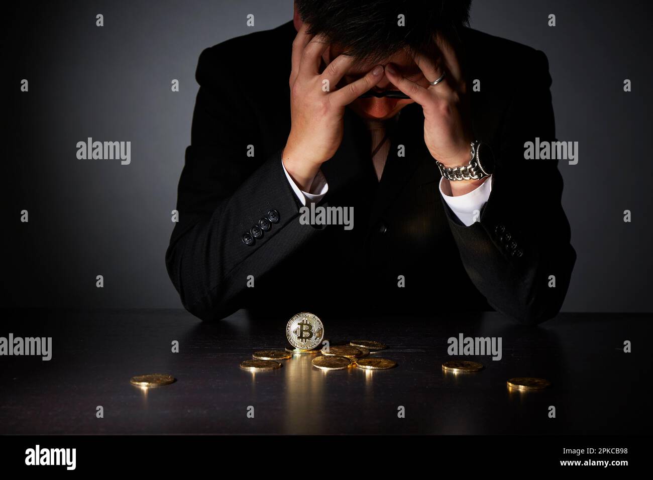 Man in suit with head held up after business failure with bitcoin Stock ...