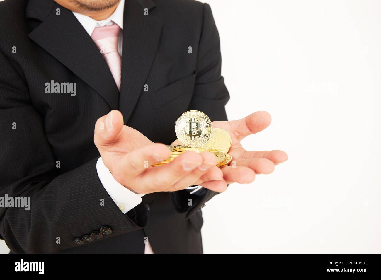 Man in suit with bitcoins Stock Photo - Alamy
