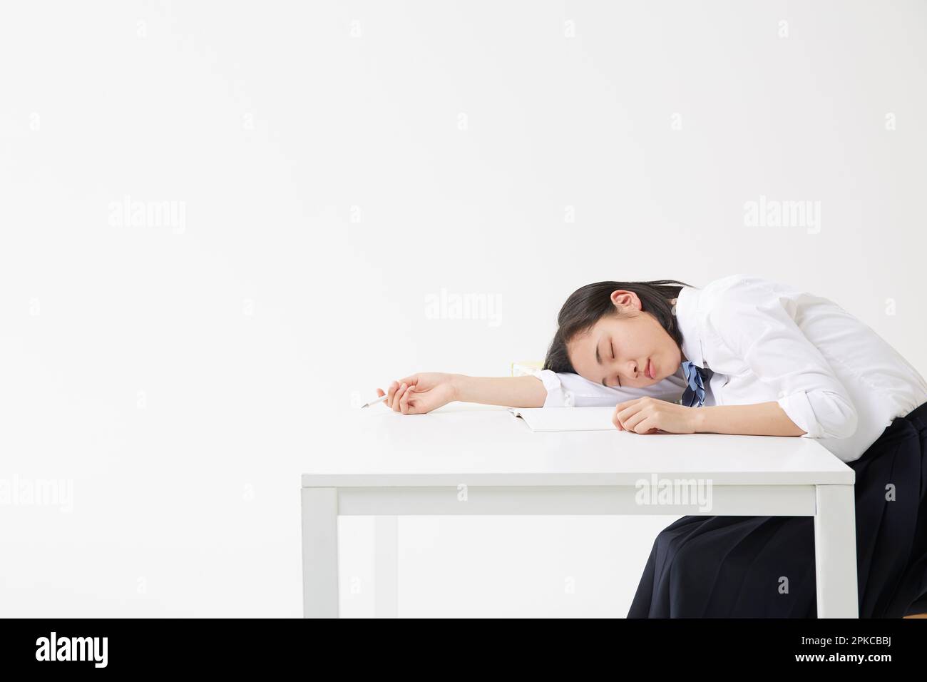 High school girls dozing off at a white table Stock Photo - Alamy