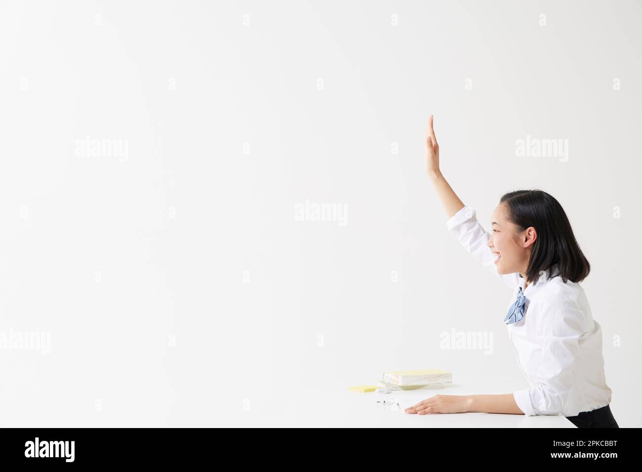 High school girls raising their hands in profile Stock Photo - Alamy