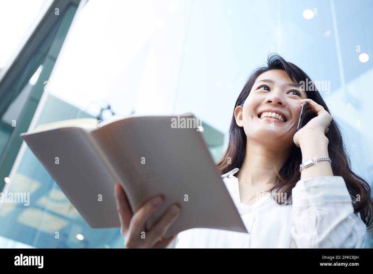 Career woman making a phone call with her schedule book open Stock ...