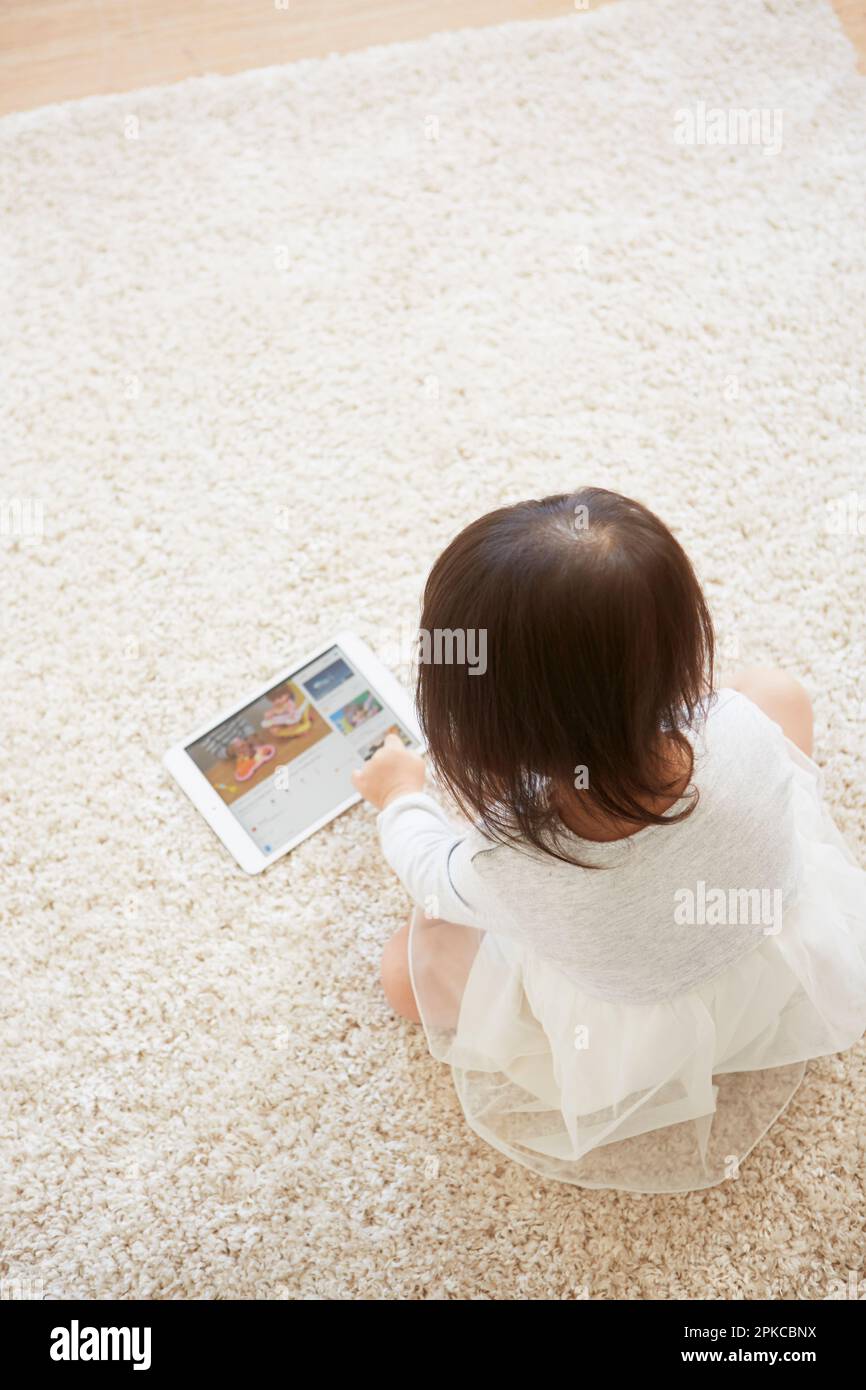 Asian girl tablet floor hi-res stock photography and images - Alamy