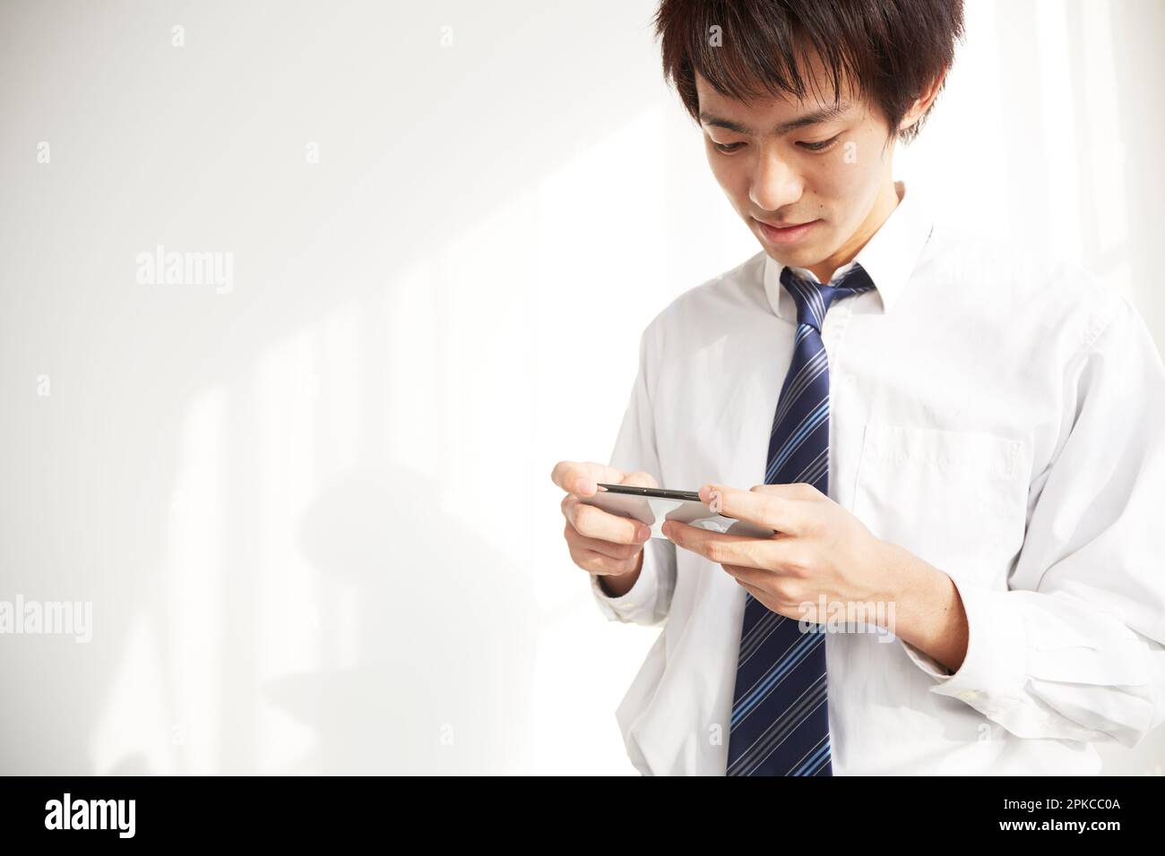 A high school boy looking at his smartphone Stock Photo - Alamy